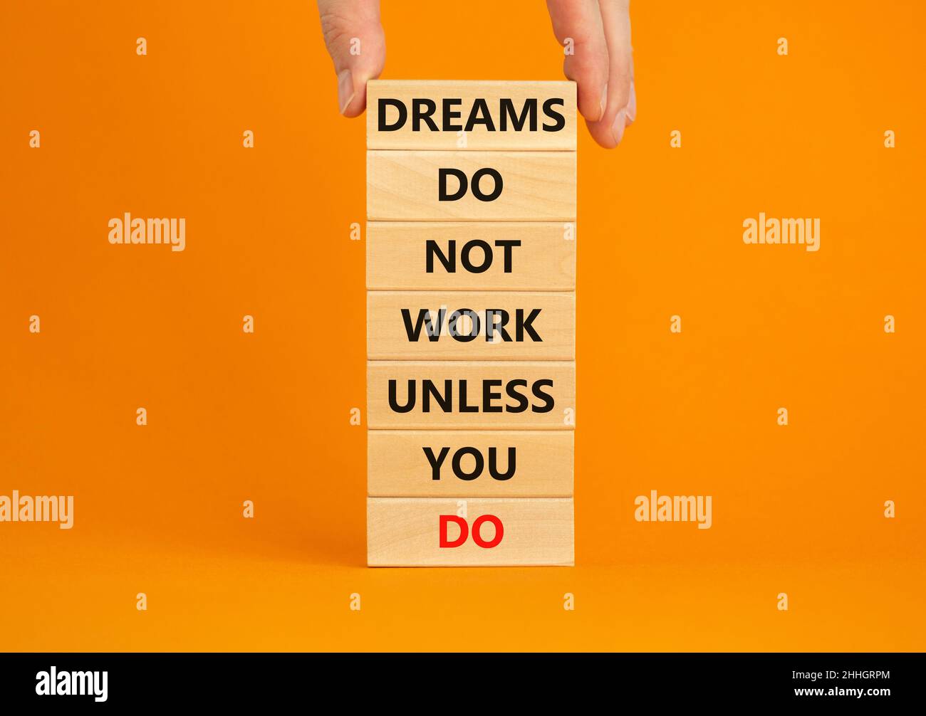 Dream and do symbol. Wooden blocks with words Dream do not work unless ...