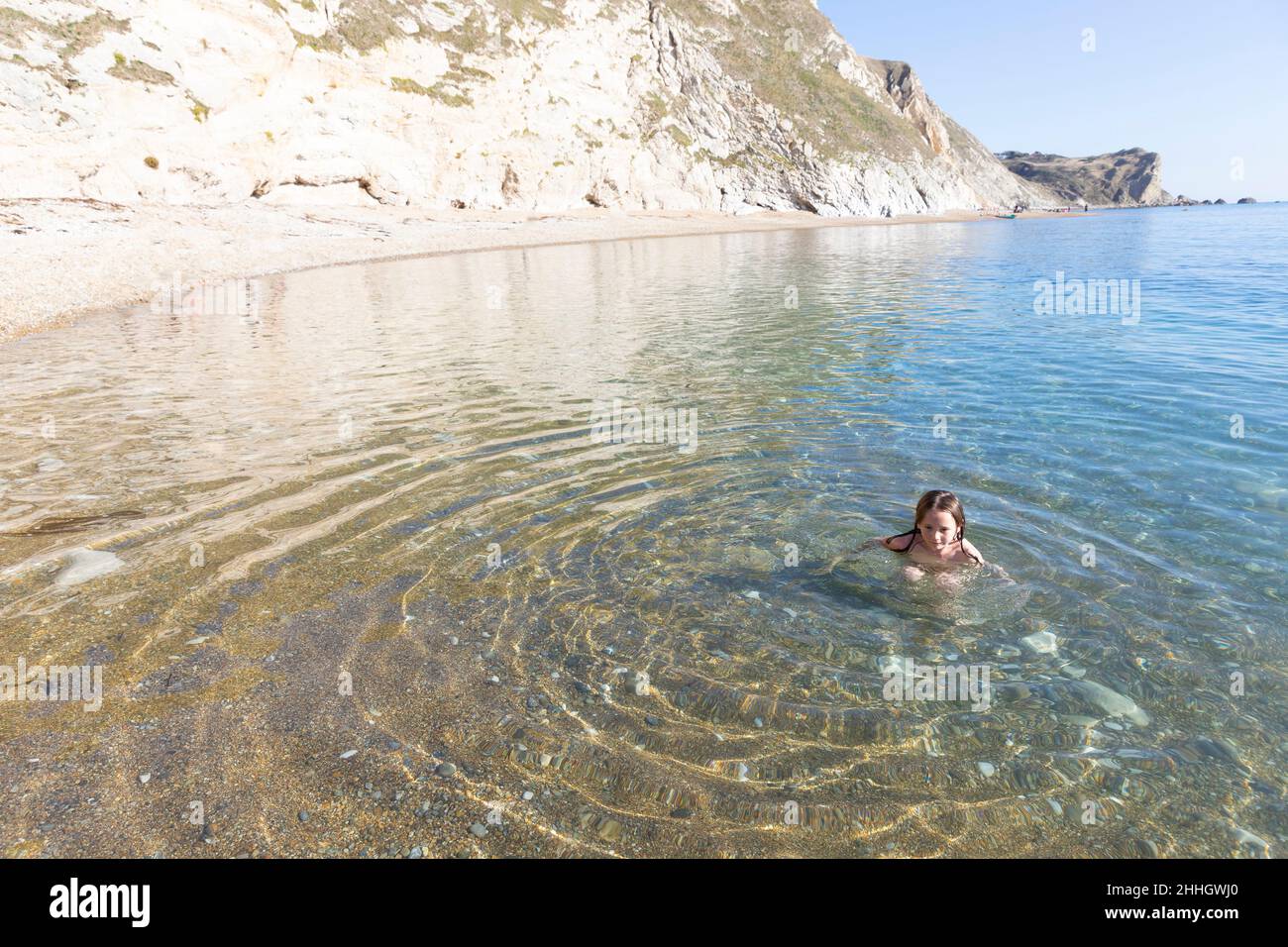 Girl swimming in sea Stock Photo - Alamy