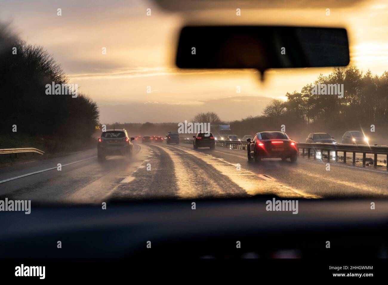 Traffic on highway at sunset seen from car Stock Photo - Alamy