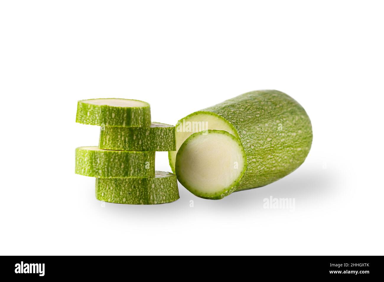 Healthy vegetables. Fresh green zucchini with a slice on a white plate ...