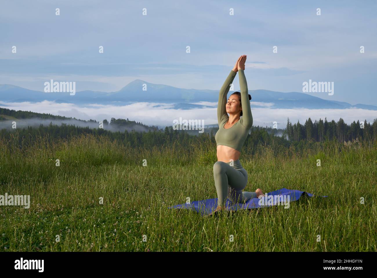 Fitness young woman with dark hair dressed in sport clothes having ...