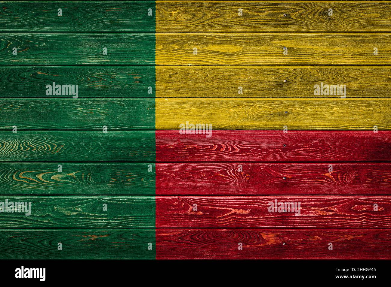 The national flag of Benin is painted on a camp of even boards nailed ...
