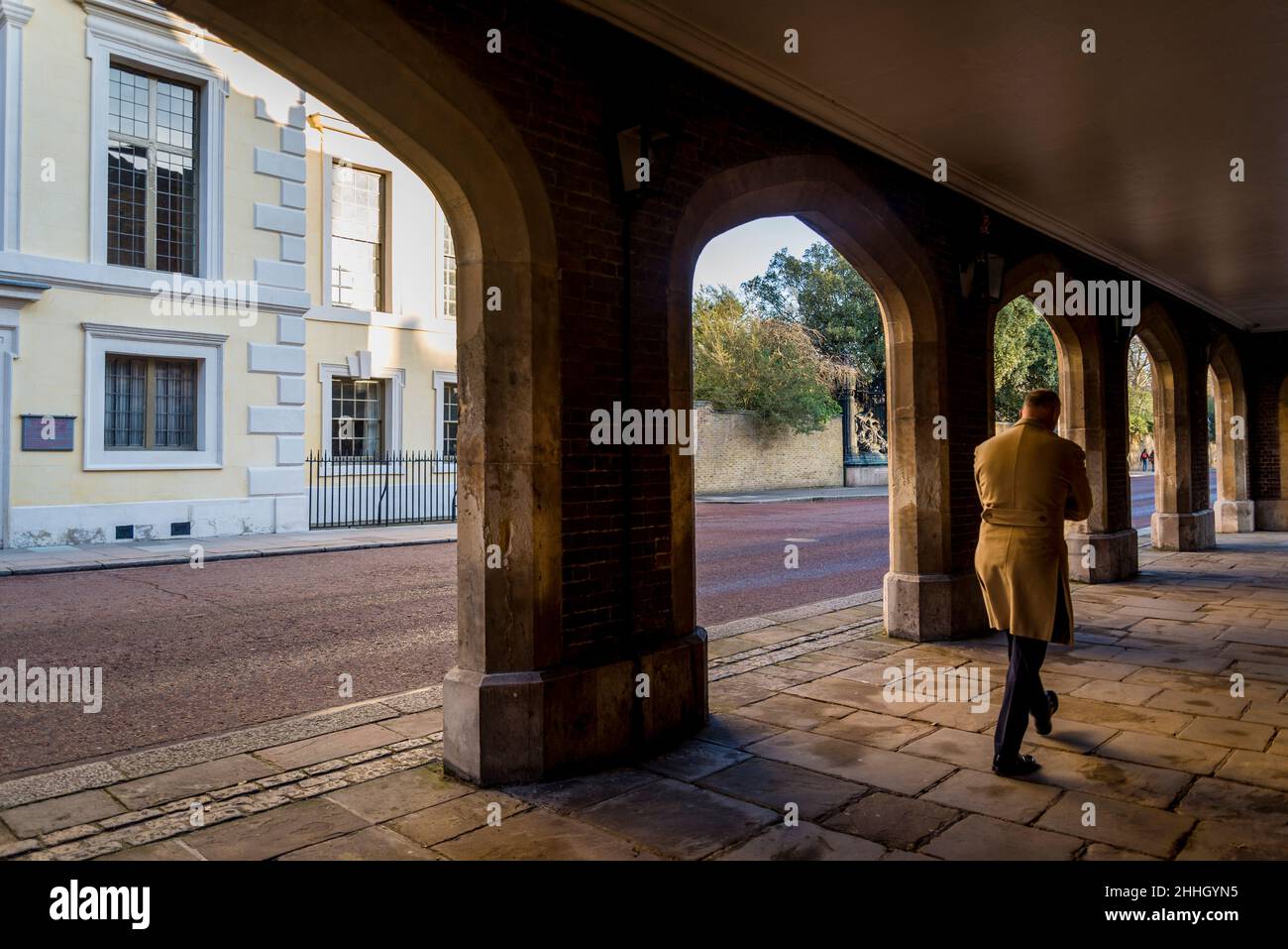 Man walking through the colonnade of St James's Palace, a royal palace ...