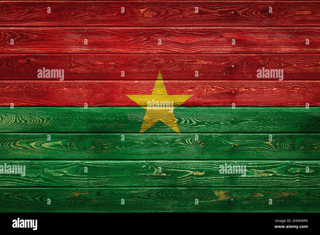 The national flag of Burkino Faso is painted on a camp of even boards ...