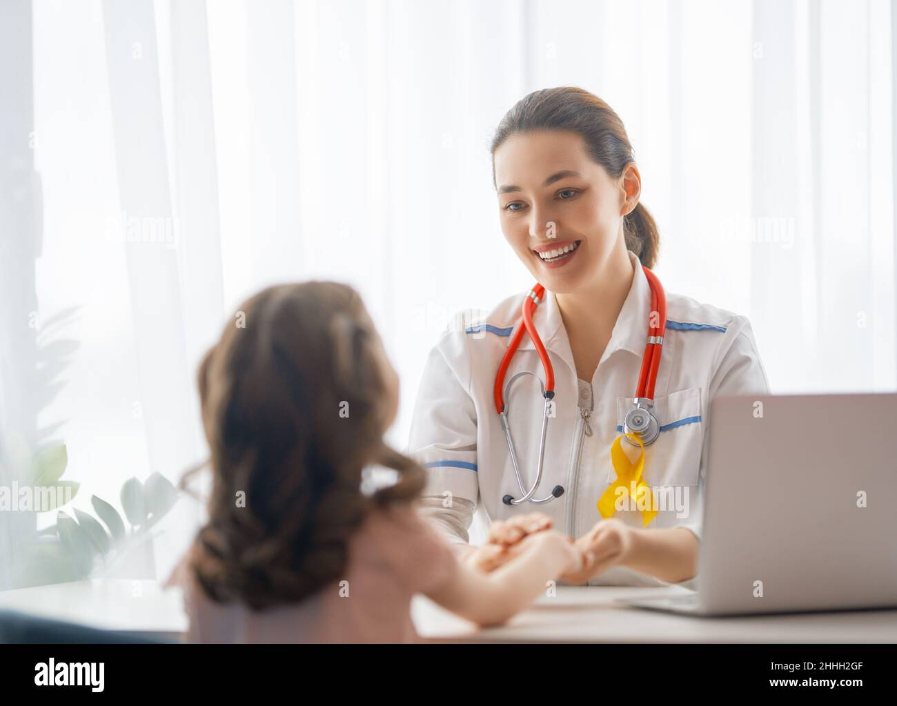 World Childhood cancer Day. Girl patient listening to a doctor in ...