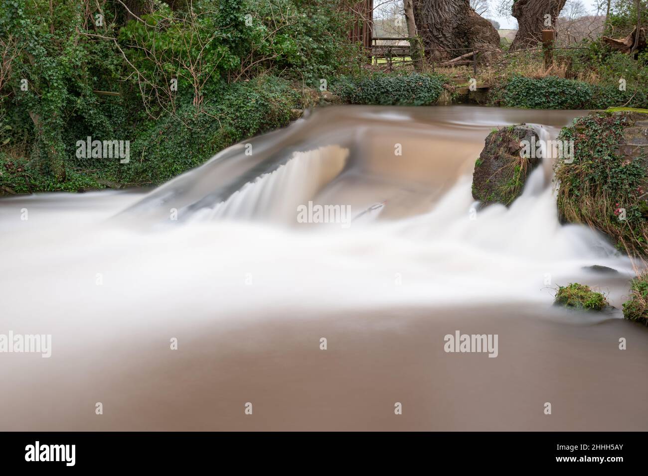 Long exposure of a waterfall on the river Avill in Dunster in Somerset ...