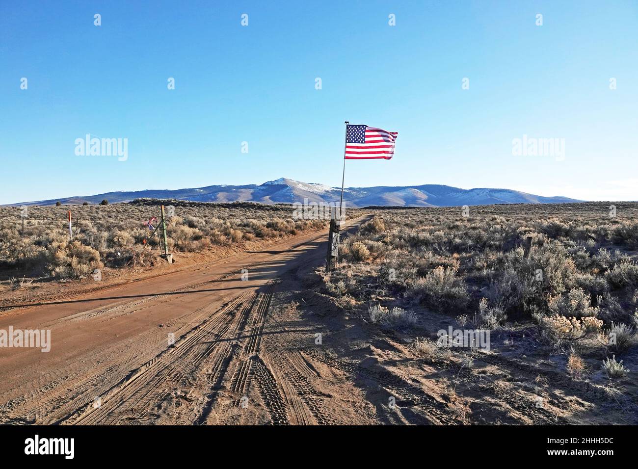 A lone American flag flies at a ranch gate in rural Oregon. Hundreds of ...