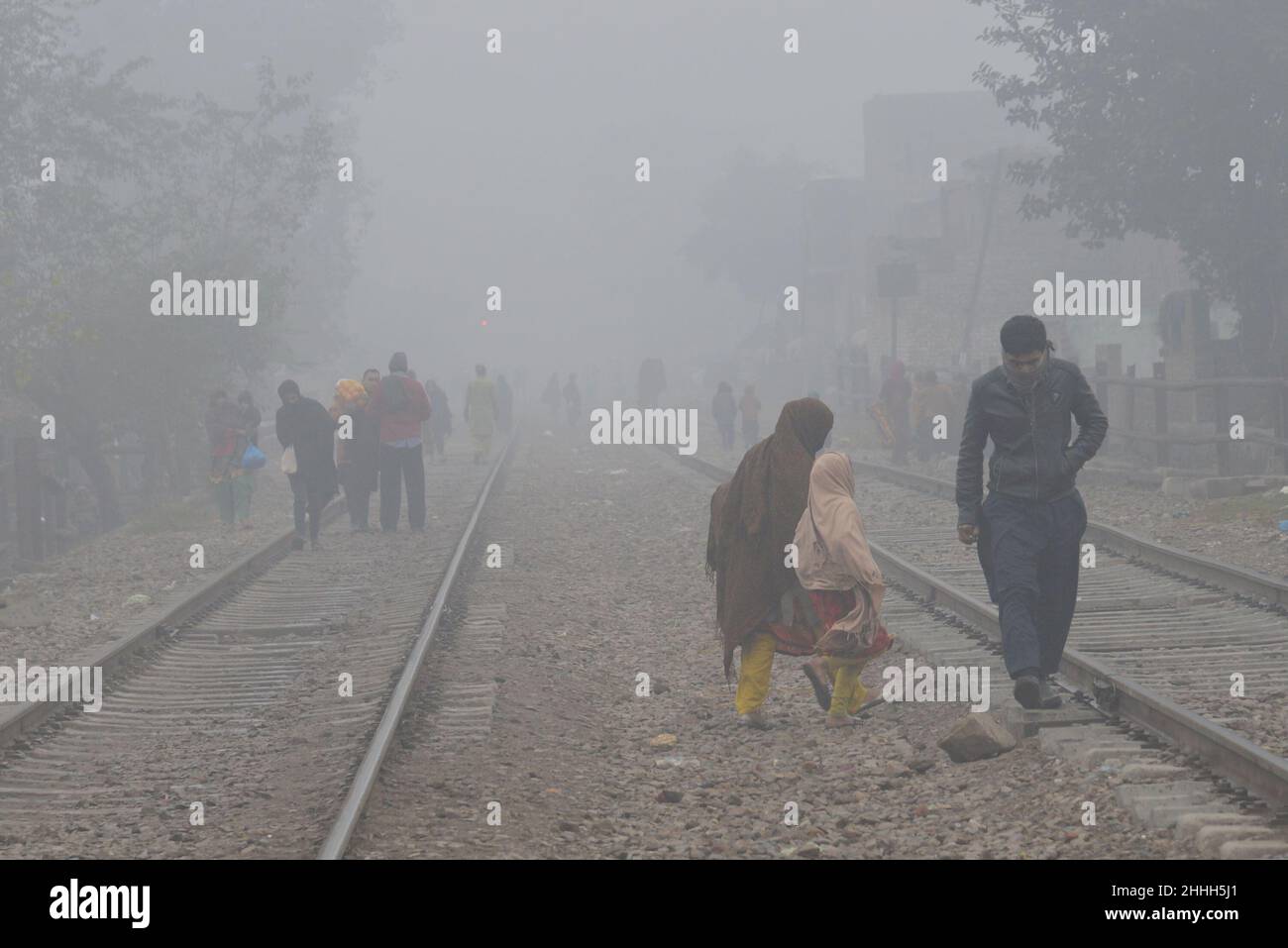 Pakistani citizens are busy in their routine life work during thick ...