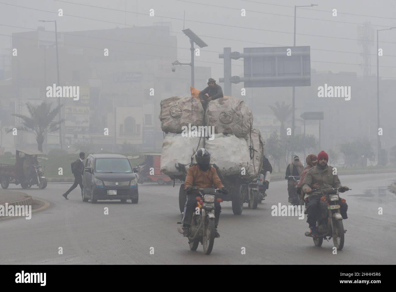Pakistani citizens are busy in their routine life work during thick ...