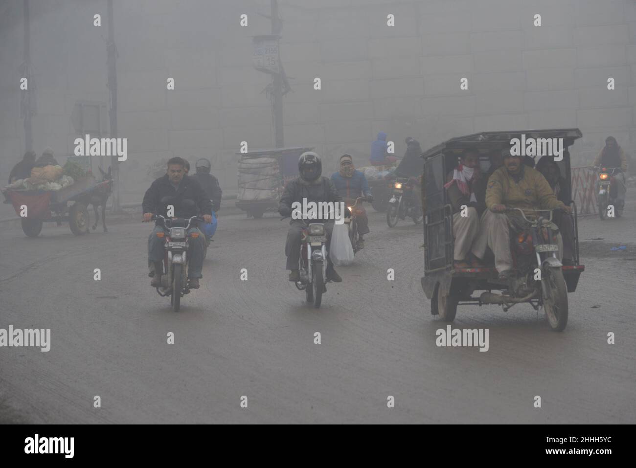 Pakistani citizens are busy in their routine life work during thick ...