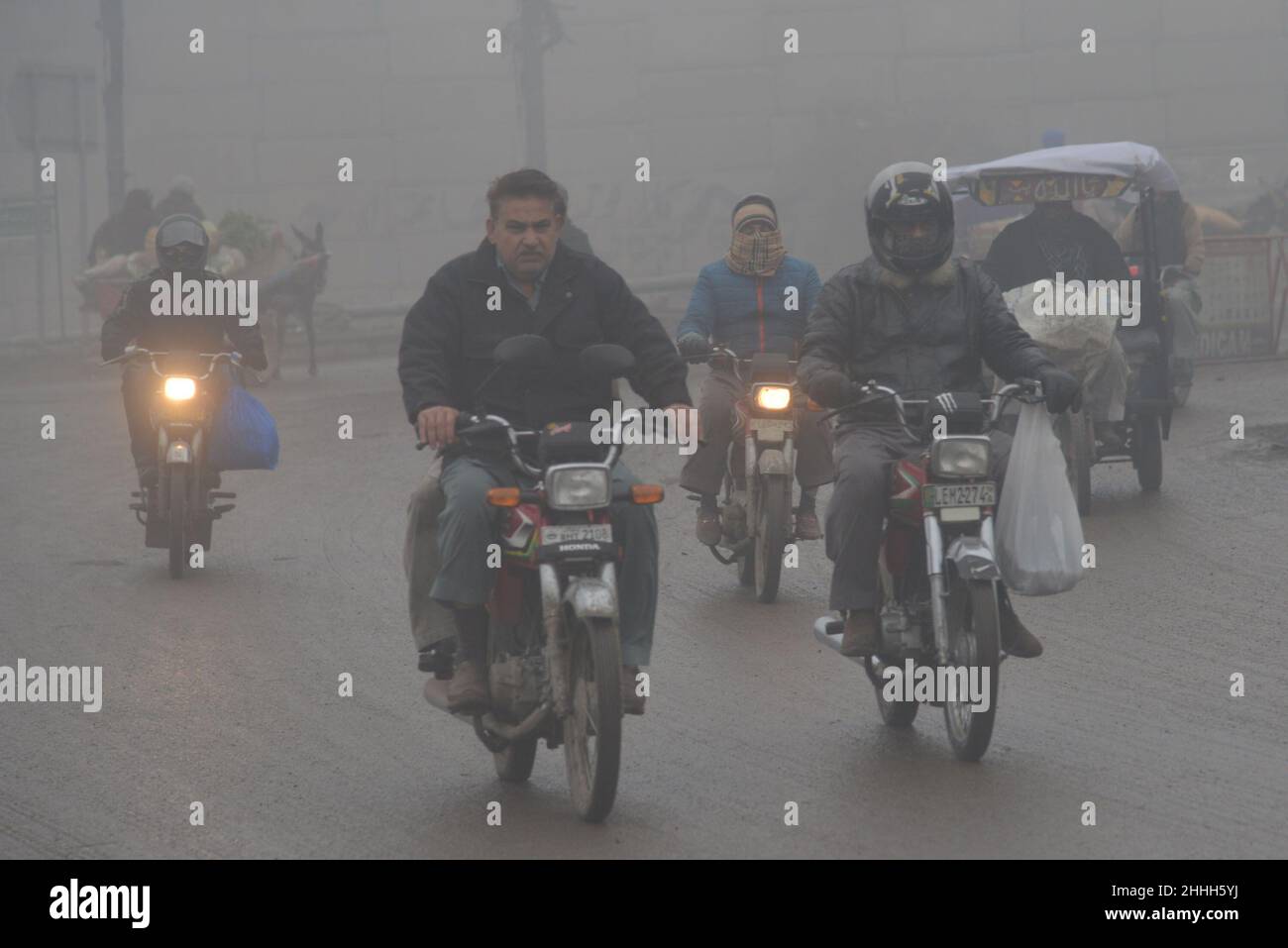 Pakistani citizens are busy in their routine life work during thick ...