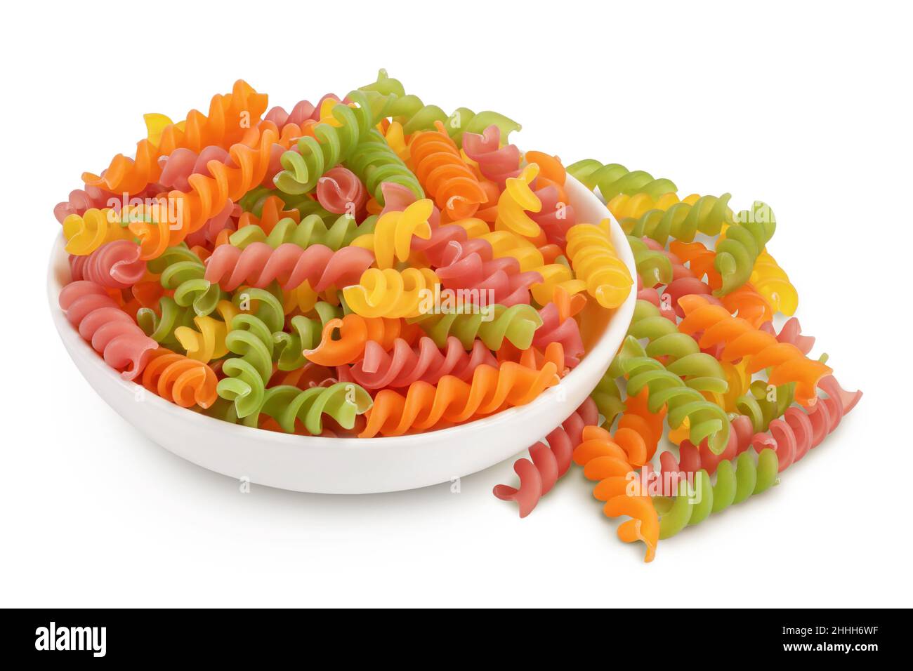 raw Fusilli in ceramic bowl colored pasta, isolated on white background ...