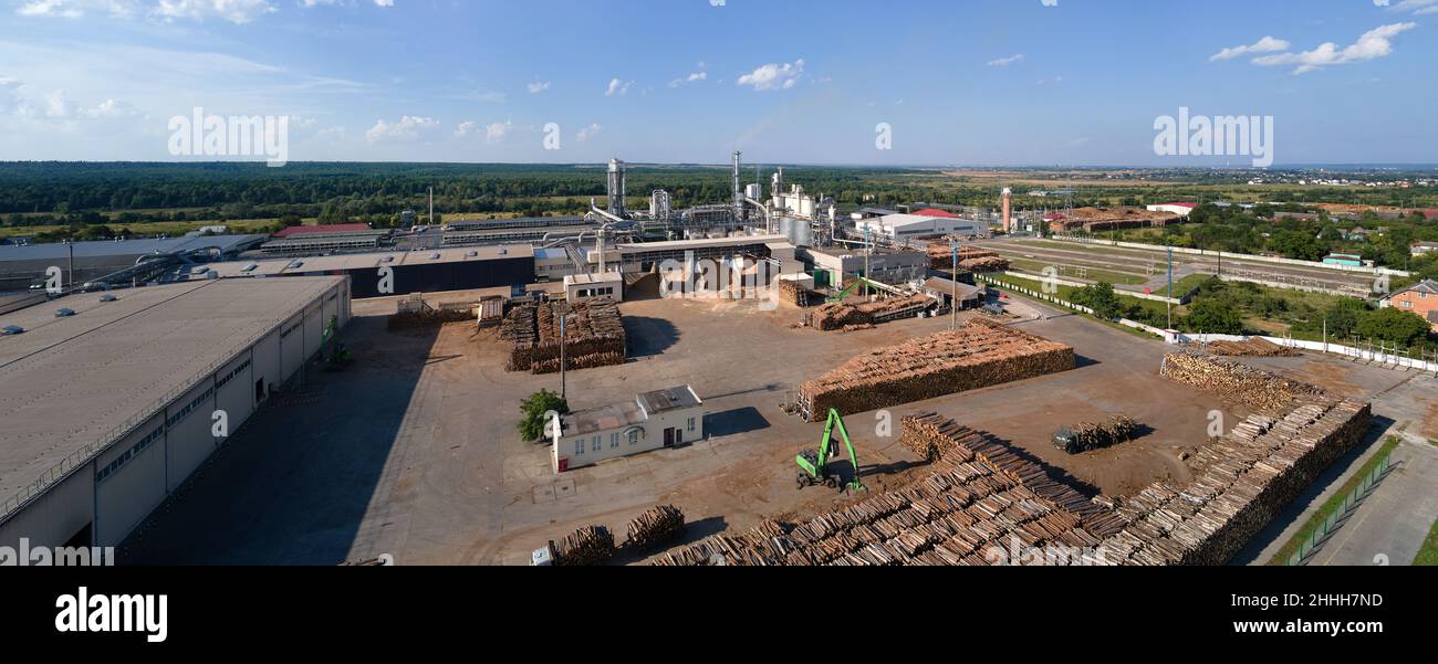 Aerial view of wood processing factory with stacks of lumber at plant ...