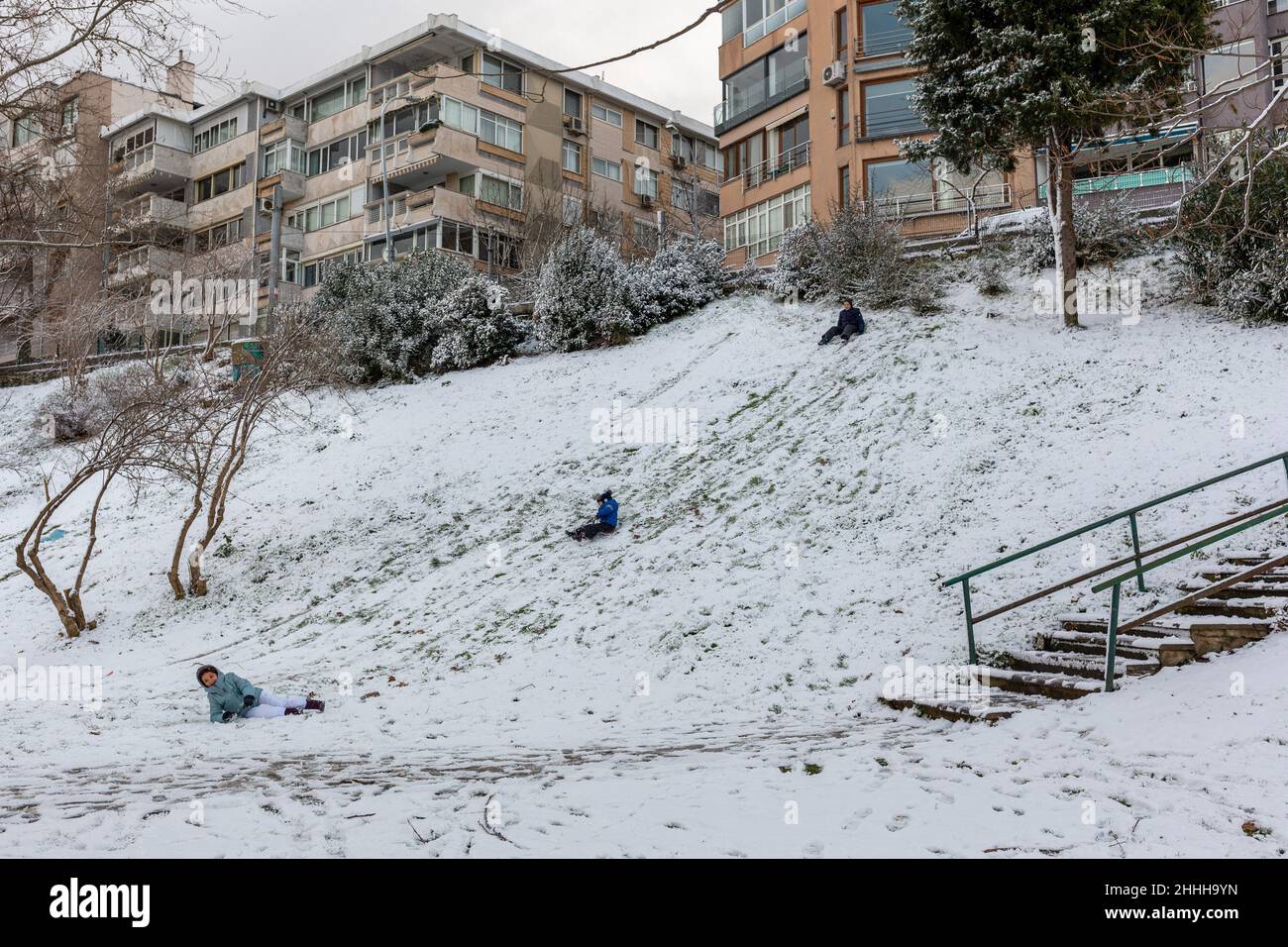 Children playing on snow. City and people views from Istanbul after ...