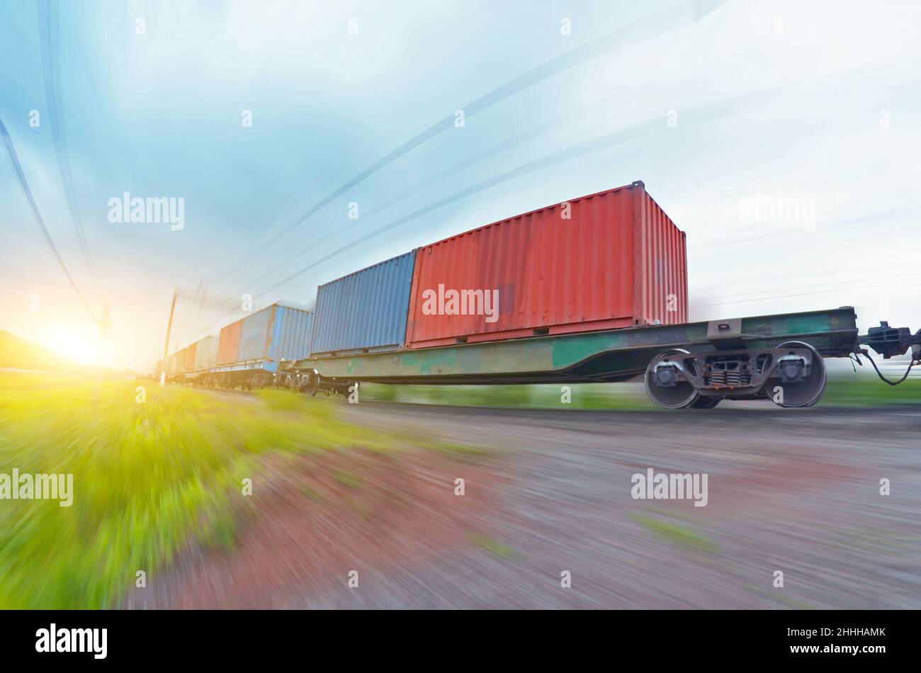 Freight train rides at speed with container and cargo at sunset Stock ...