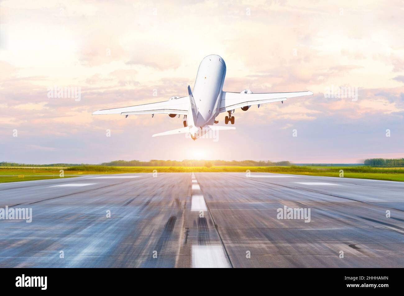 Passenger airplane take off from the runway before the light from the sunshine Stock Photo - Alamy