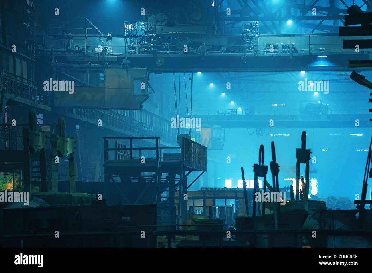 Metallurgy factory interior in blue color. Industrial zone with cranes ...