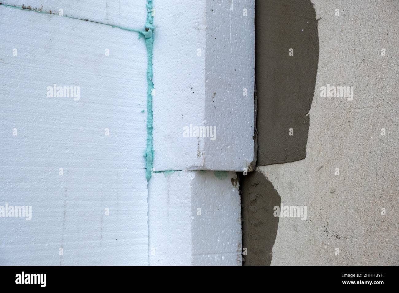 Installation of styrofoam insulation sheets on house facade wall for ...