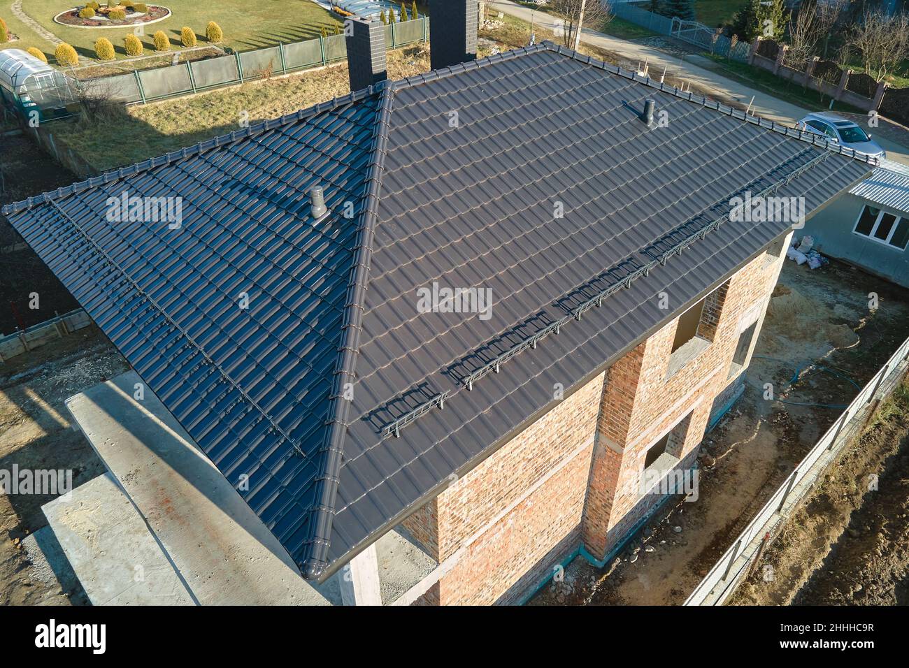 Aerial view of house roof top covered with ceramic shingles. Tiled ...