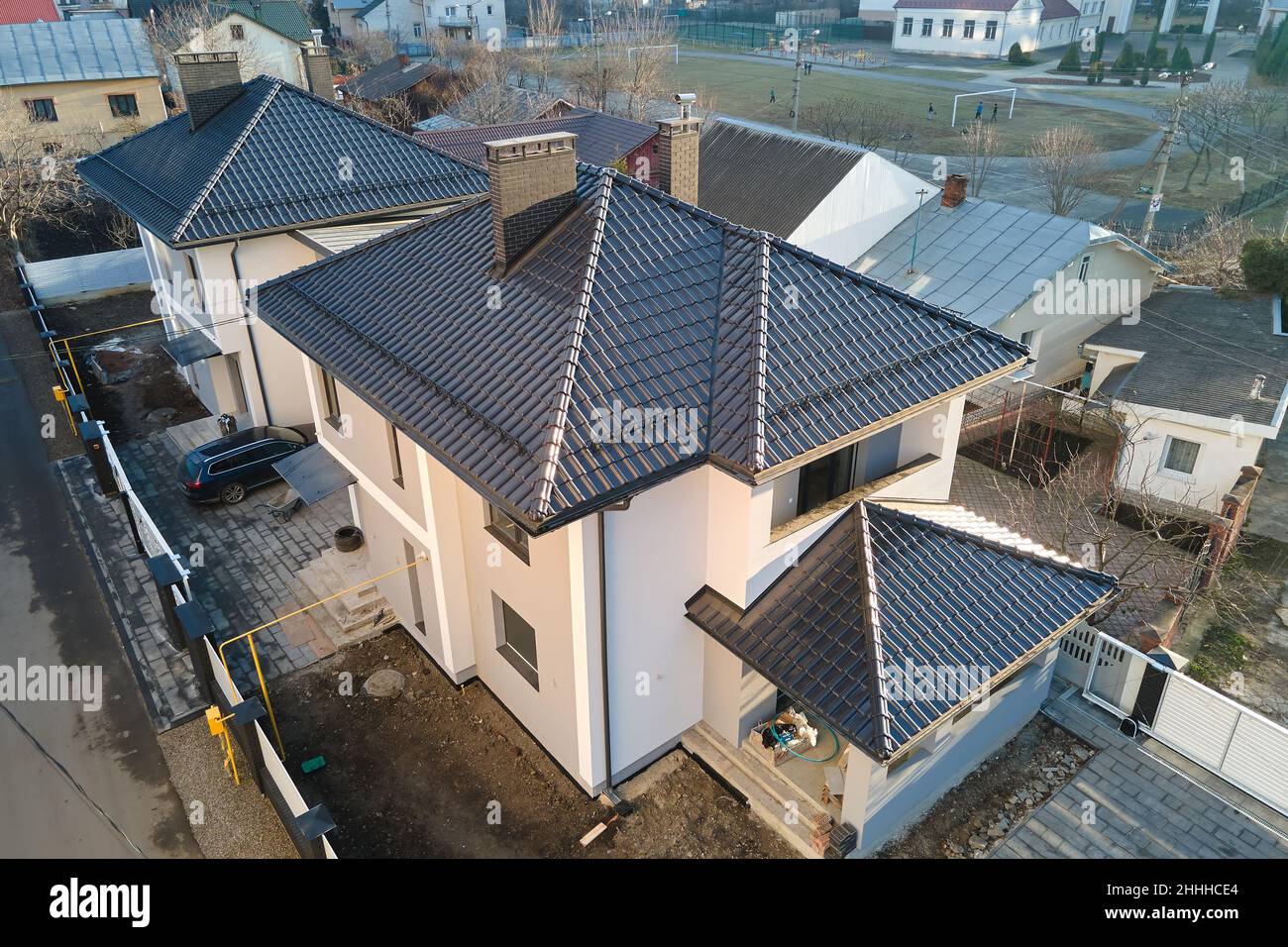 Aerial view of private house with ceramic shingles covered roof top ...