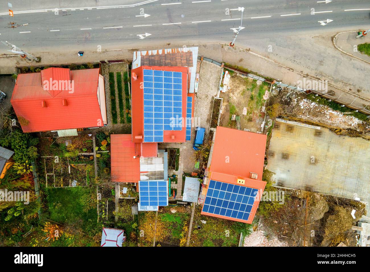 Aerial view of residential houses with rooftops covered with solar ...