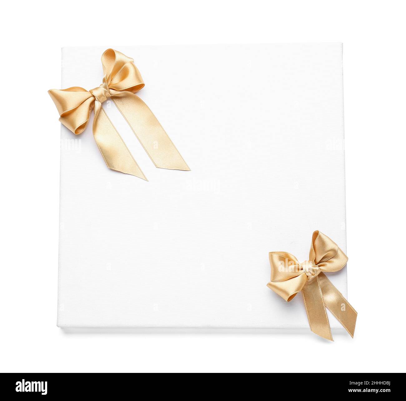 Blank board with golden ribbon bows on white background Stock Photo - Alamy
