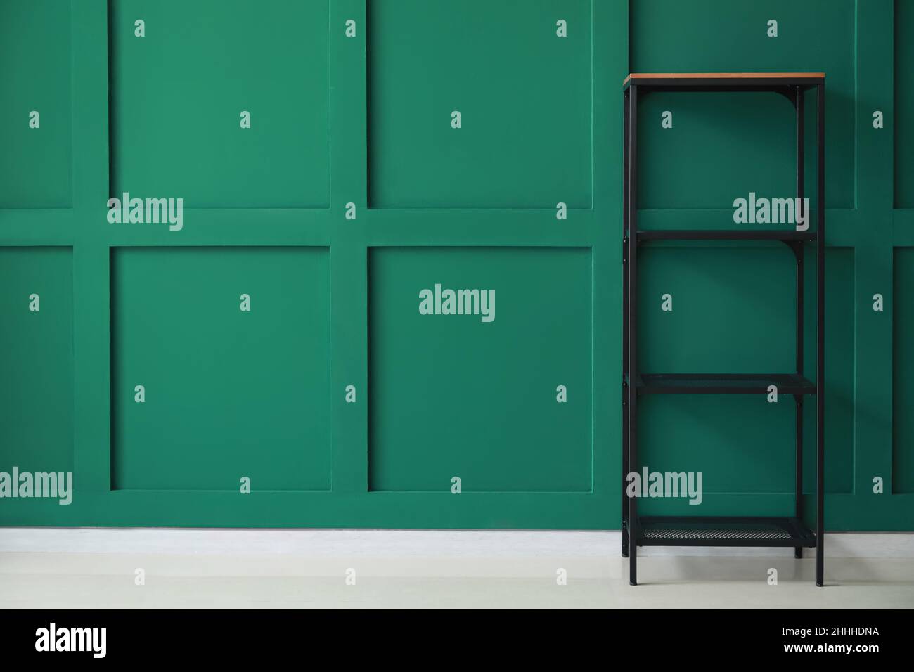 Empty modern shelf unit near green wall in room Stock Photo - Alamy