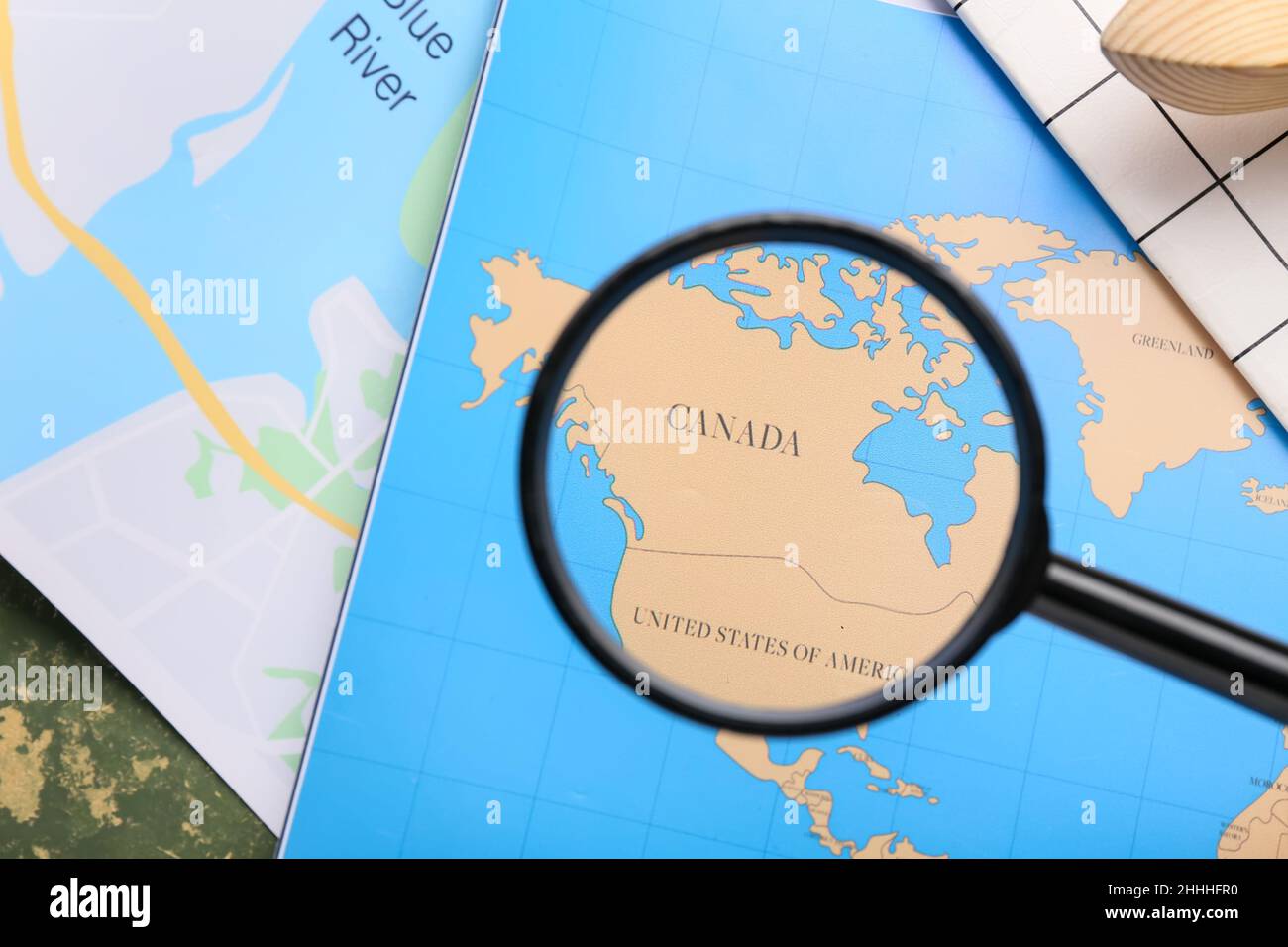 Magnifying glass and world map, closeup Stock Photo - Alamy