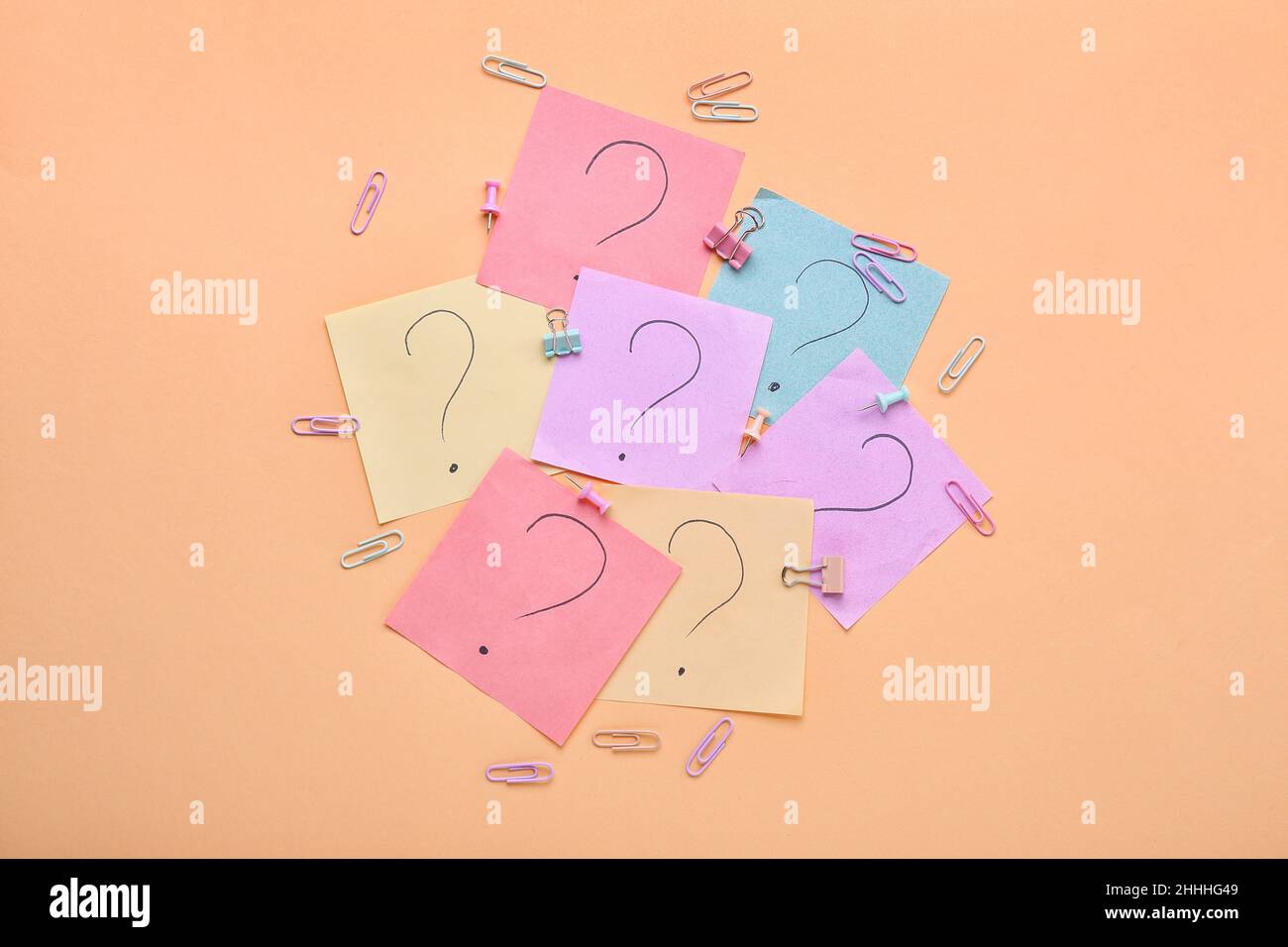 Paper sticks with question marks and clips on beige background Stock ...