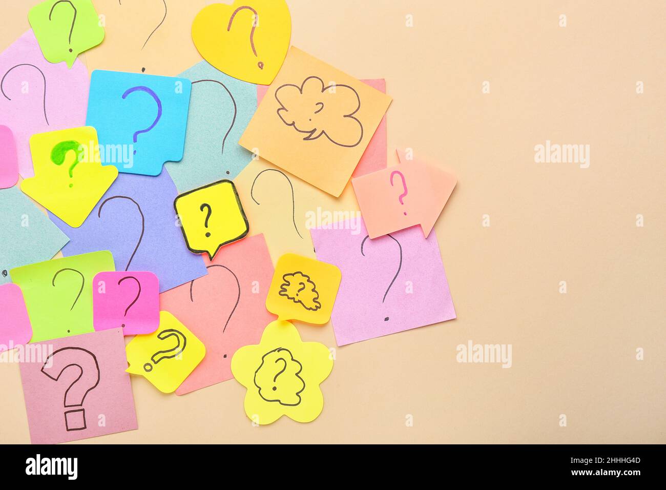 Paper sticks with question marks on beige background Stock Photo - Alamy
