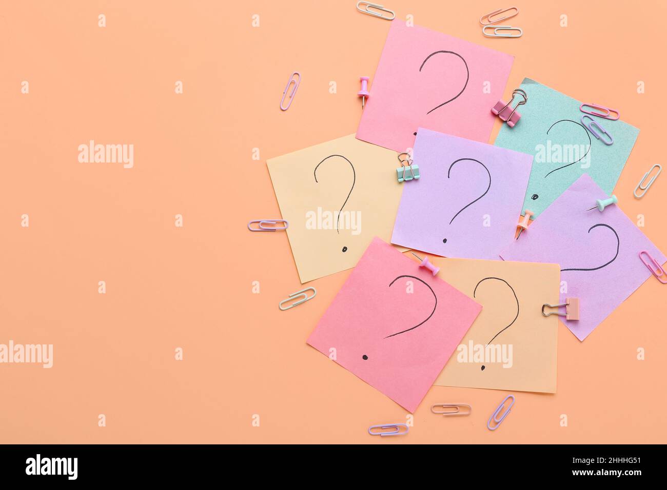 Paper sticks with question marks and clips on beige background Stock ...
