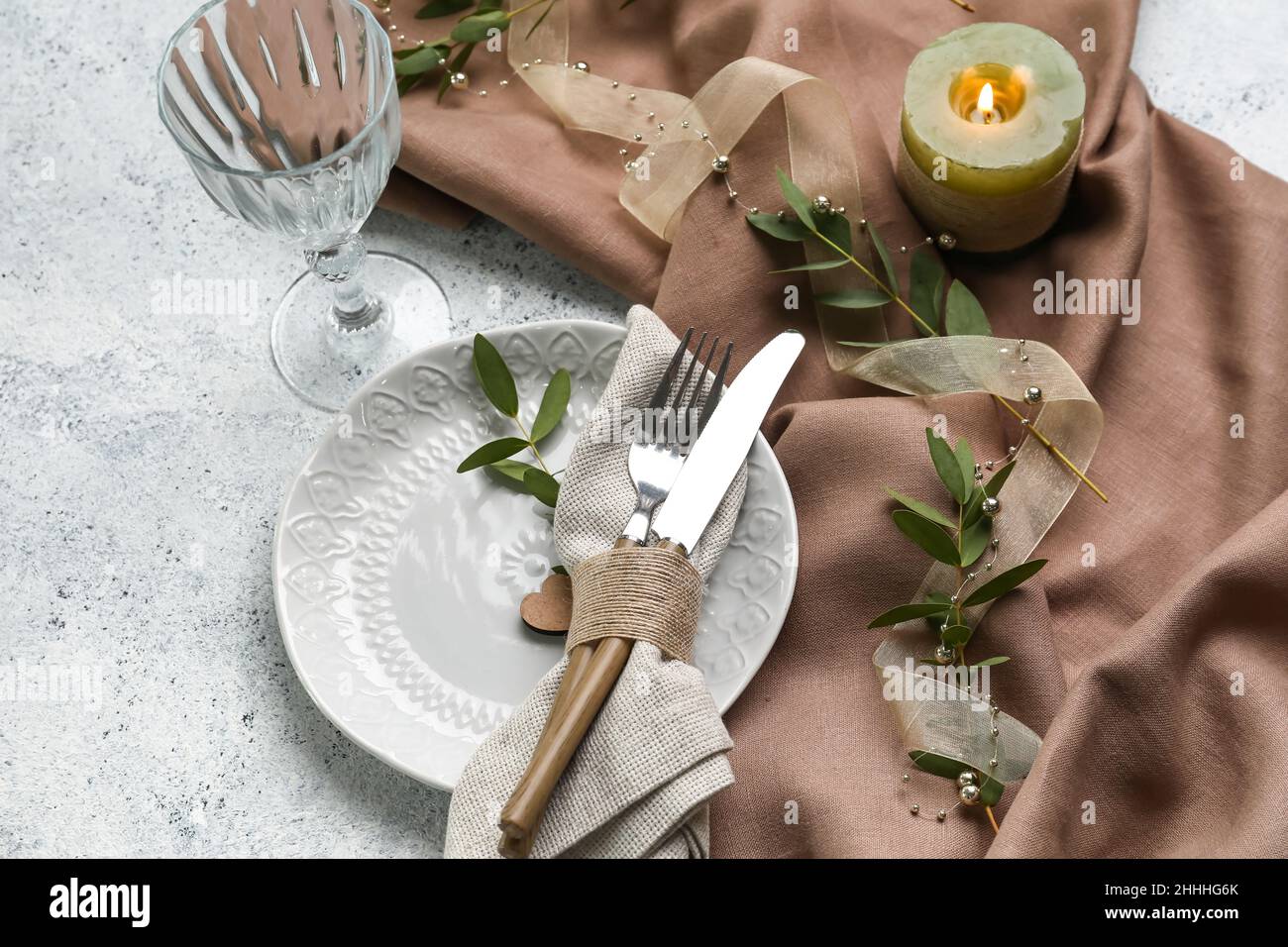 Beautiful table setting for wedding and candle on light background ...