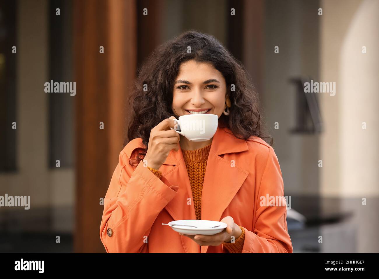 Beautiful woman drinking tea outdoors Stock Photo - Alamy