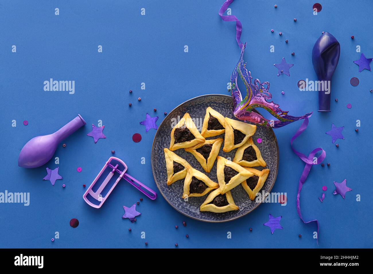 Carnival mask and Hamantaschen cookies with rattle for Purim holiday on ...