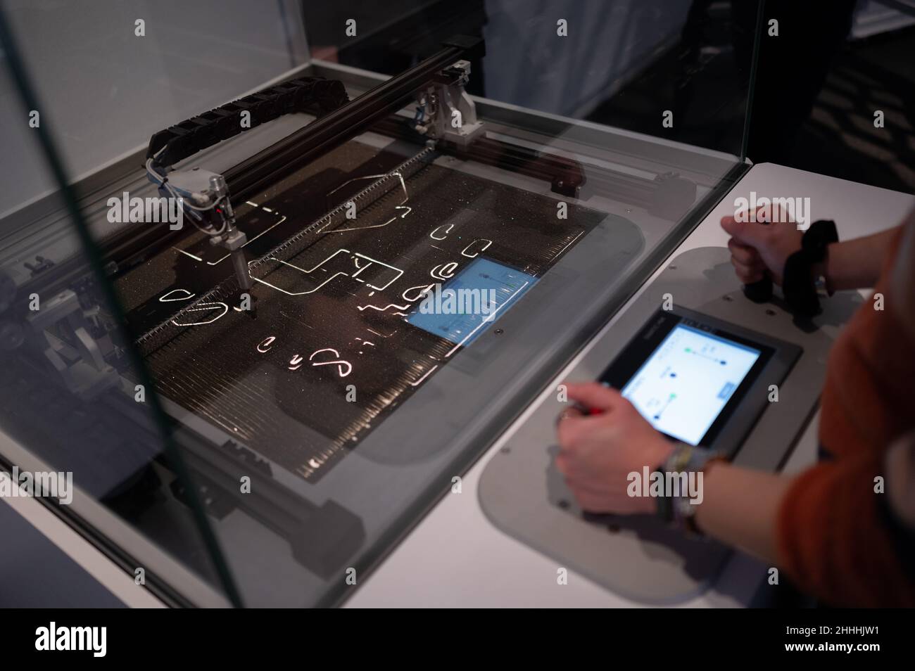 Student uses machine for drawing and learning about dimensions and two ...