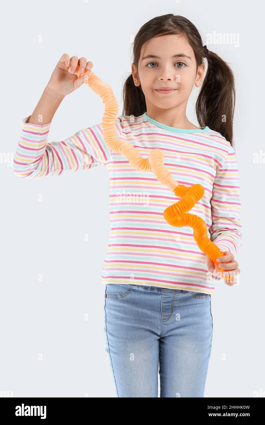 Little girl with orange Pop Tubes on white background Stock Photo - Alamy