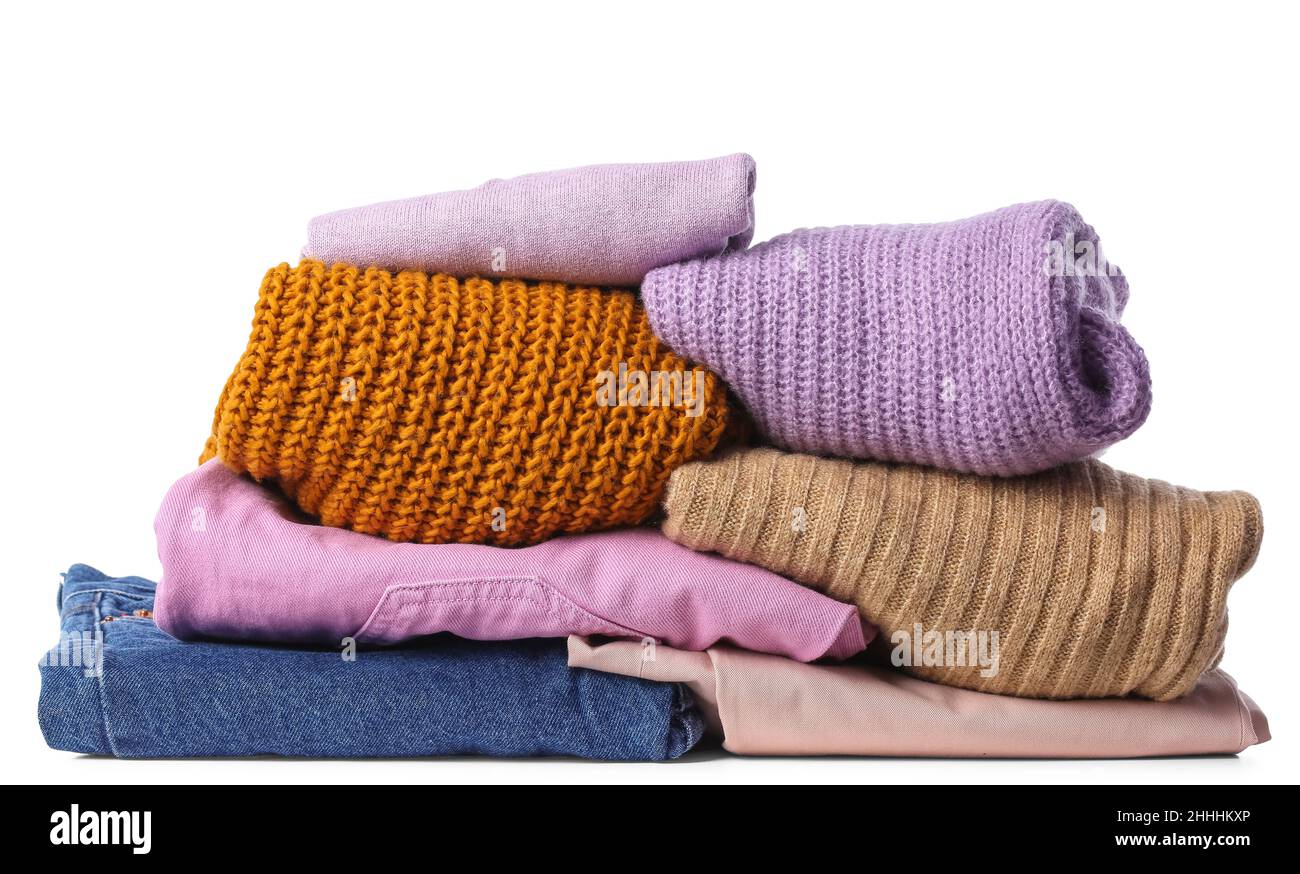 Stack of stylish female clothes on white background Stock Photo - Alamy