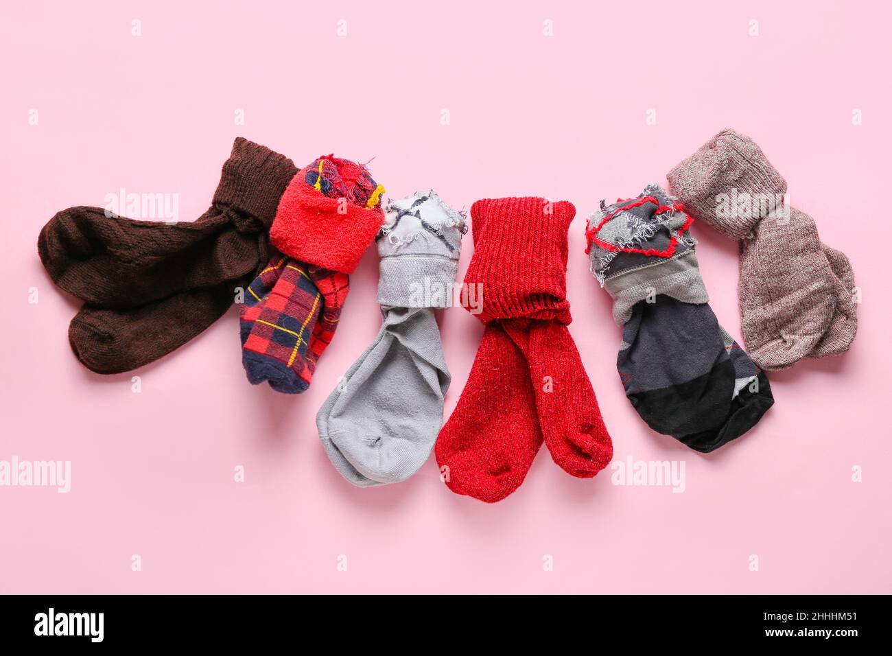 Different socks on pink background Stock Photo - Alamy
