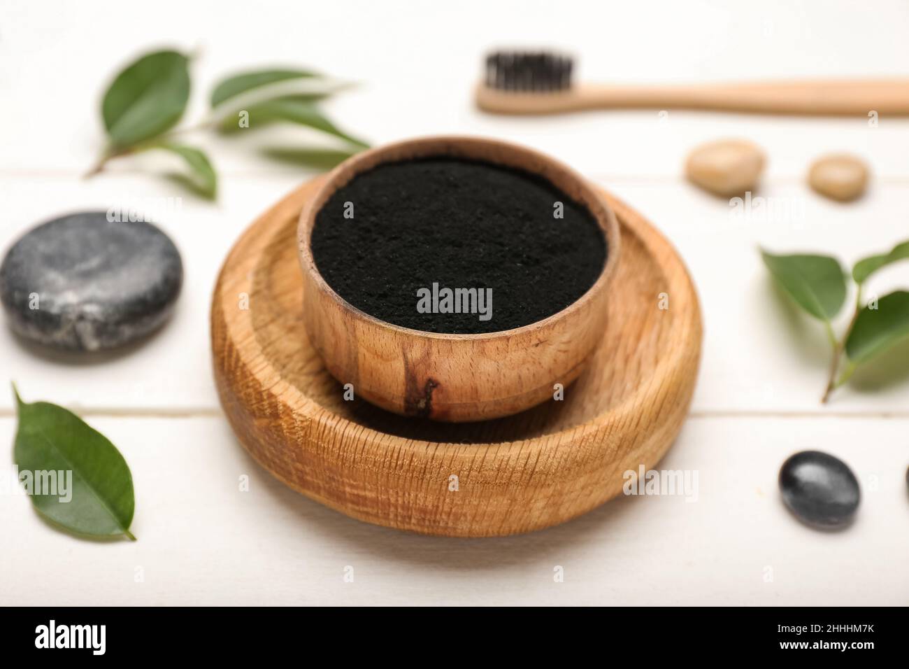 Bowl with activated charcoal tooth powder on white wooden background Stock Photo - Alamy