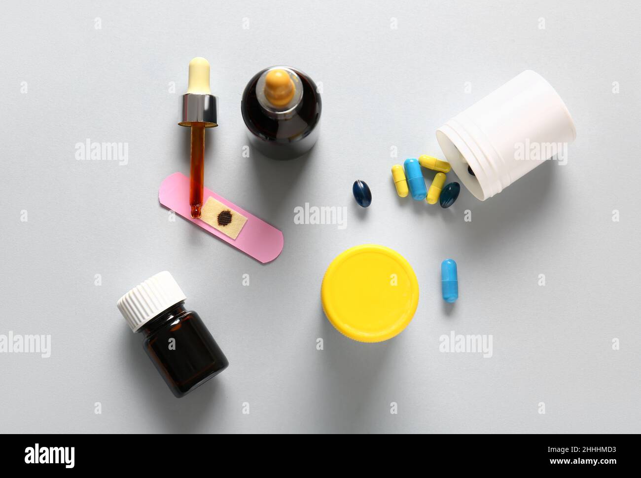 Bottles with iodine, medical plaster and pills on grey background Stock ...