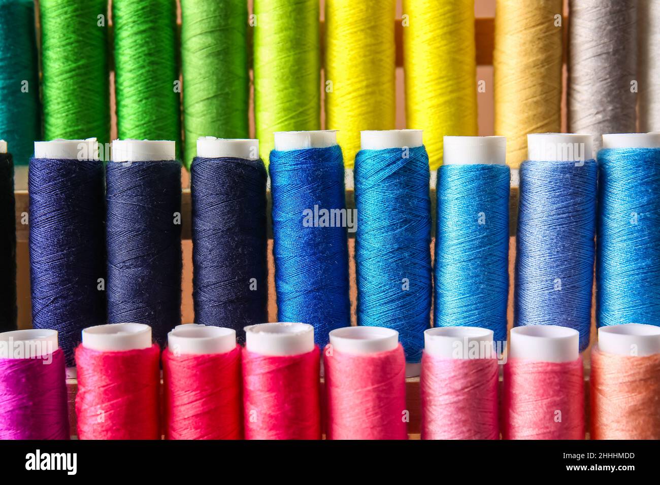 Different sewing threads on coils as background Stock Photo - Alamy
