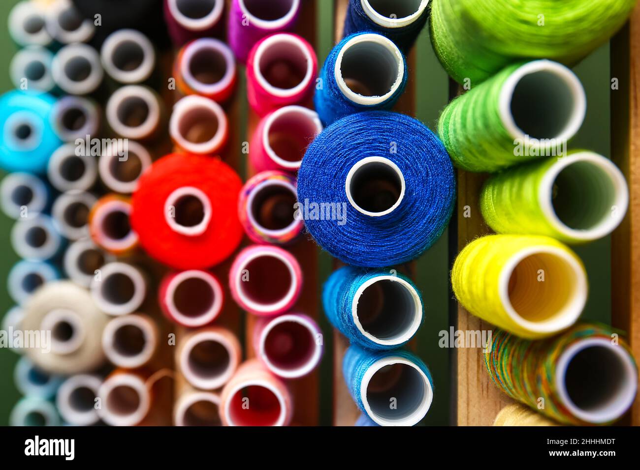 Different beautiful sewing threads on coils Stock Photo - Alamy