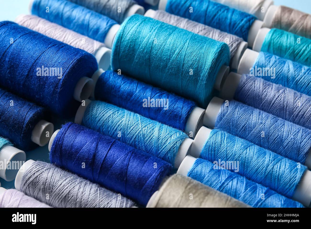 Spools with grey and blue sewing threads, closeup Stock Photo - Alamy