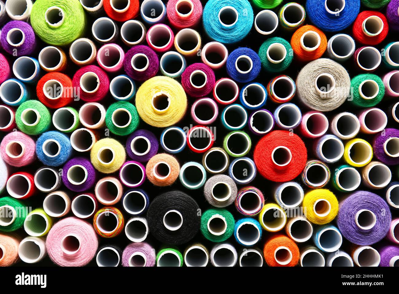 Set of spools with different sewing threads as background Stock Photo ...