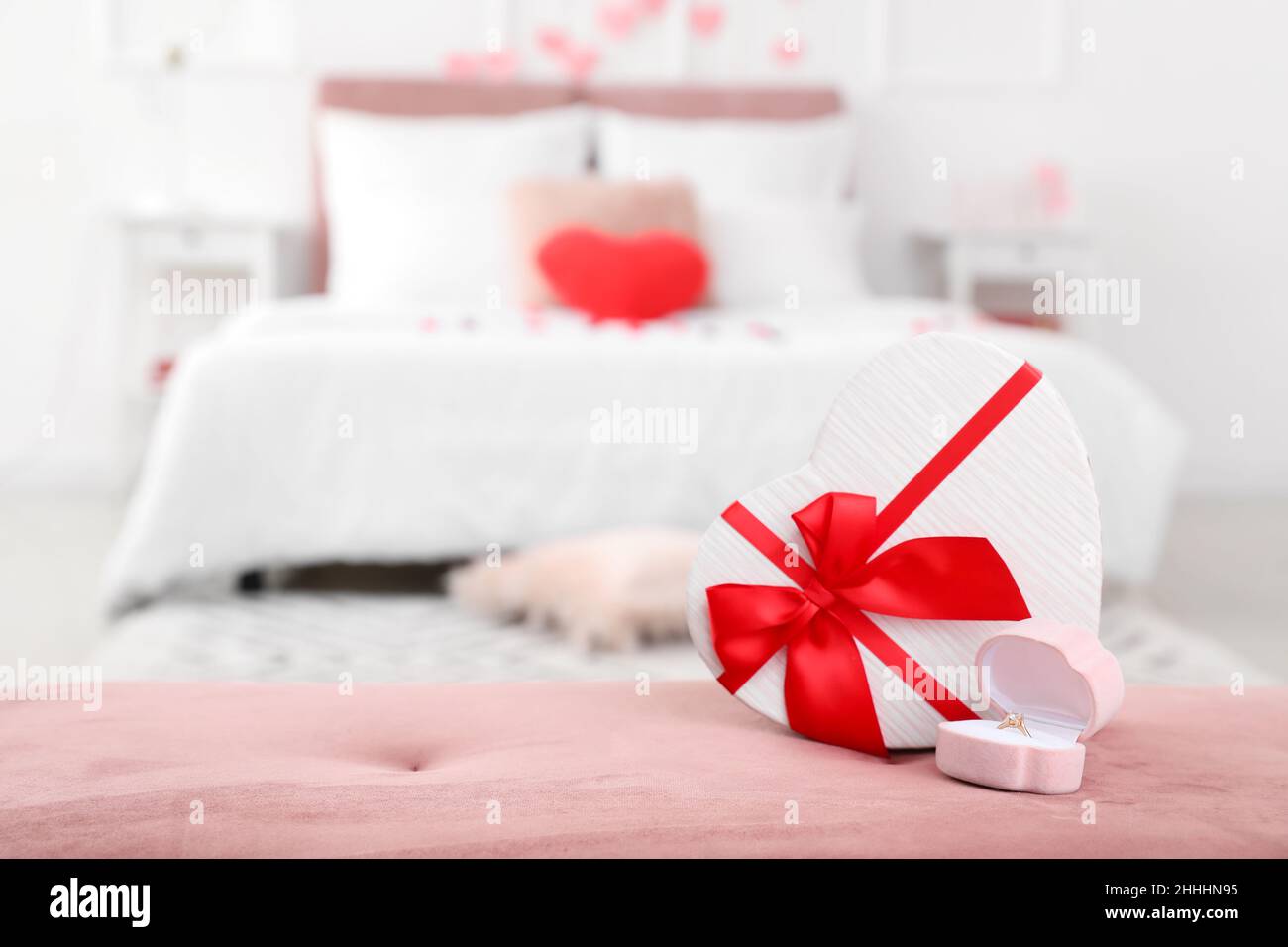 Gift box and engagement ring on bench in bedroom Stock Photo - Alamy
