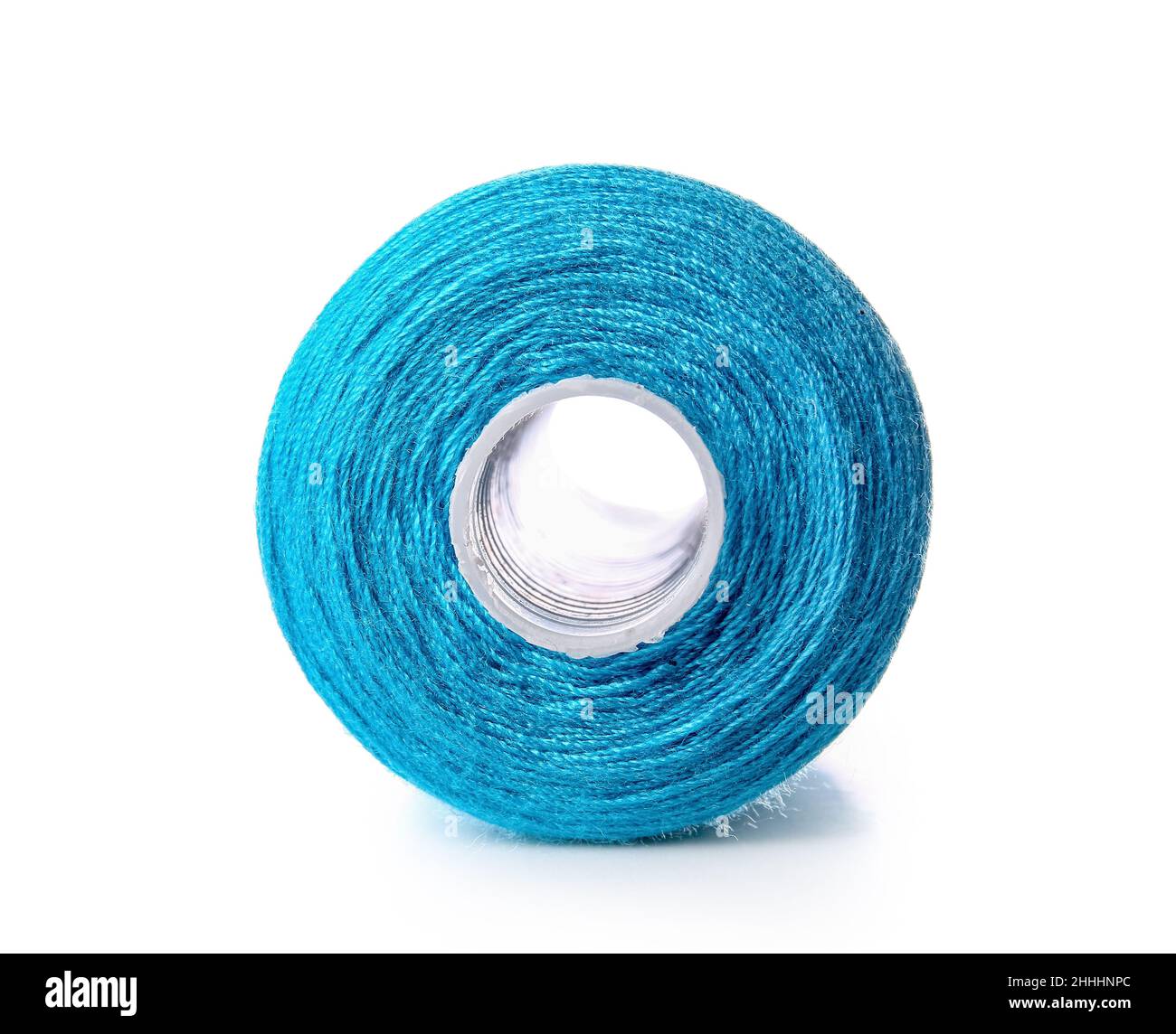 Blue sewing thread spool on white background Stock Photo - Alamy
