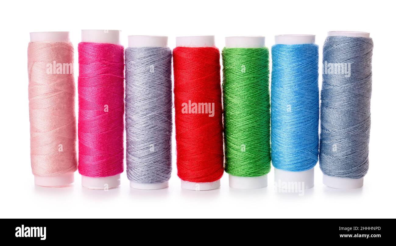 Different sewing thread spools on white background Stock Photo - Alamy
