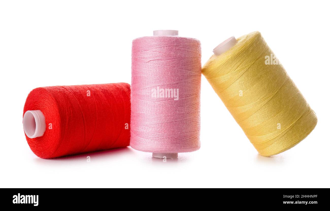 Different sewing thread spools on white background Stock Photo - Alamy