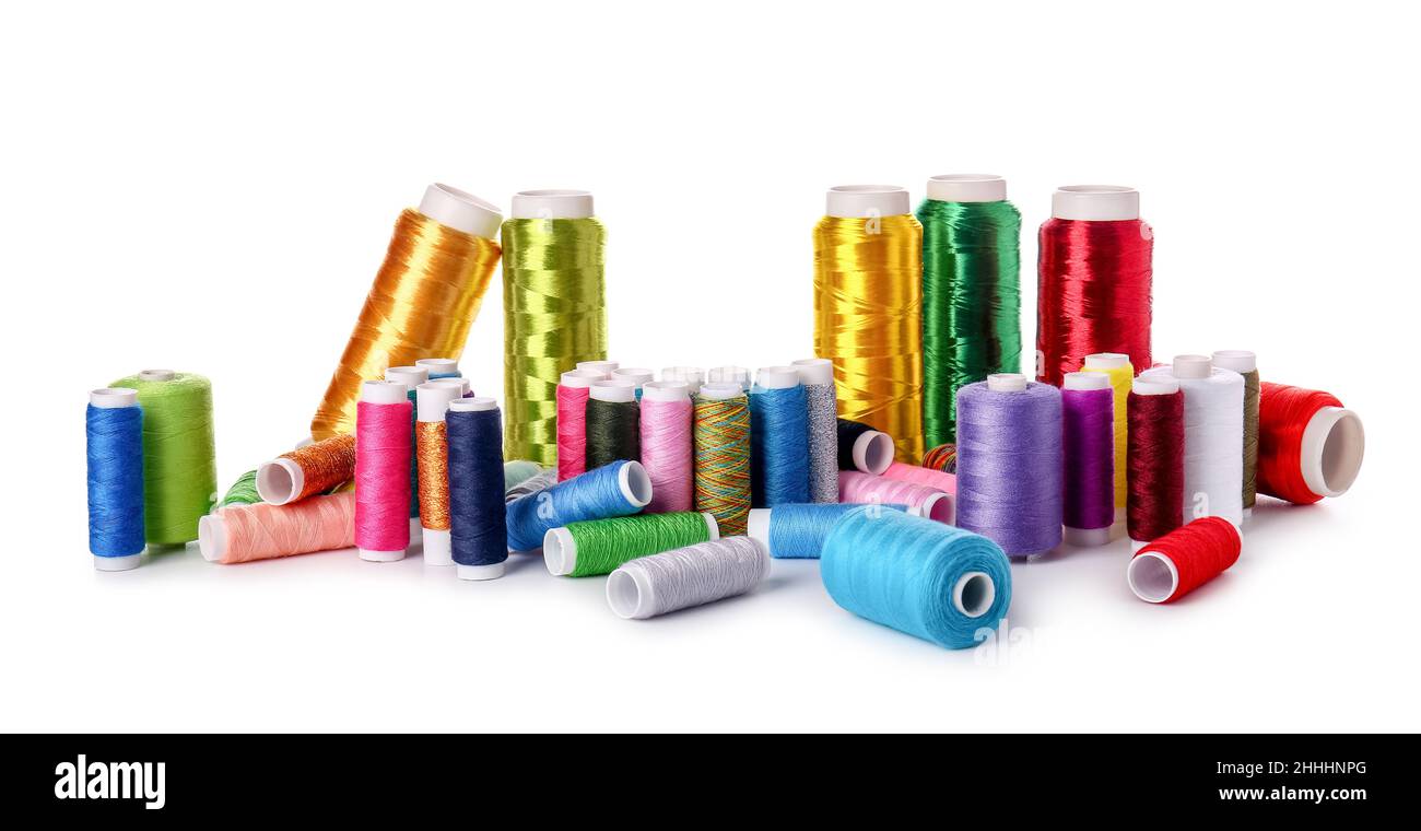 Different sewing thread spools on white background Stock Photo - Alamy