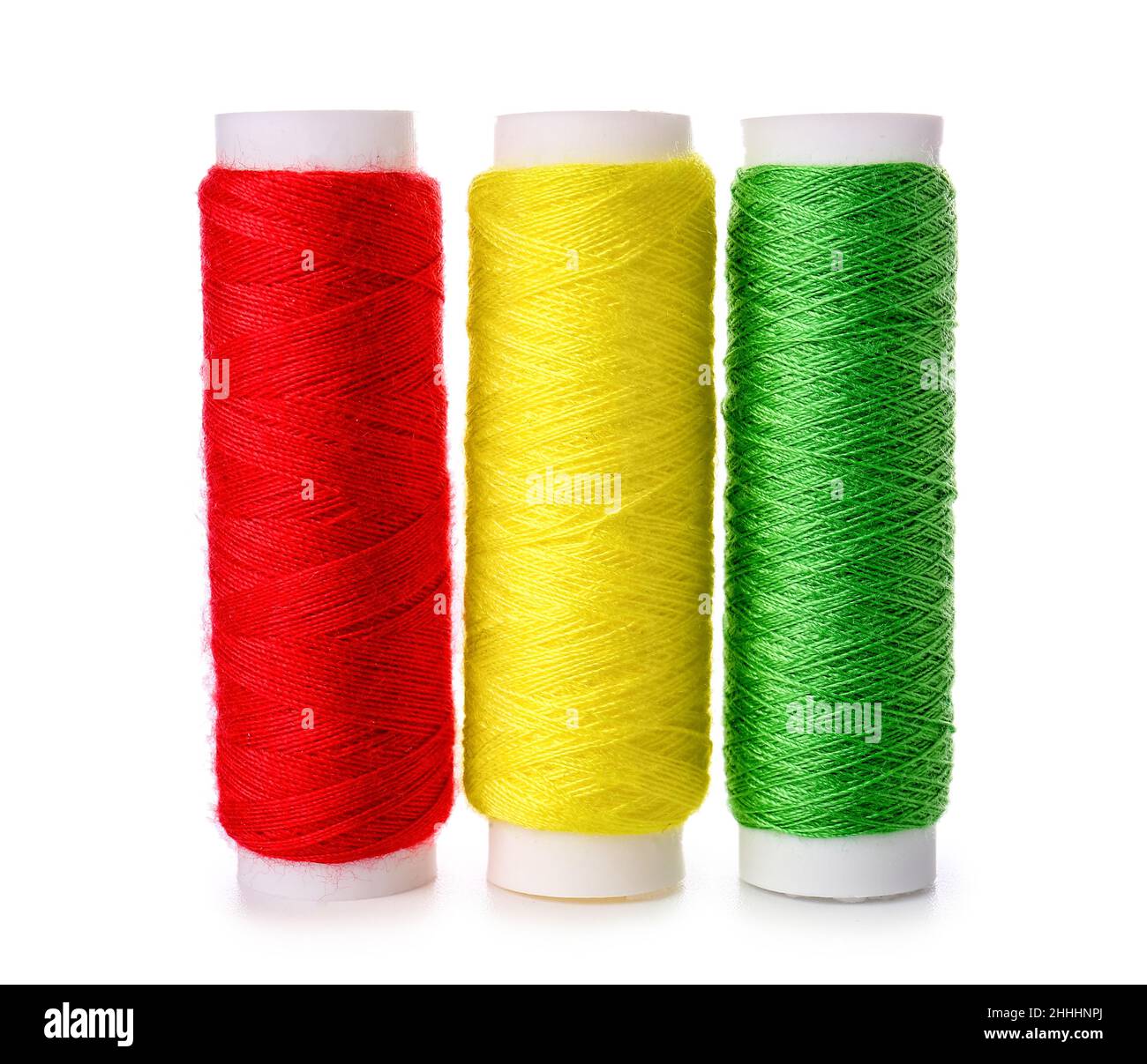 Different sewing thread spools on white background Stock Photo - Alamy